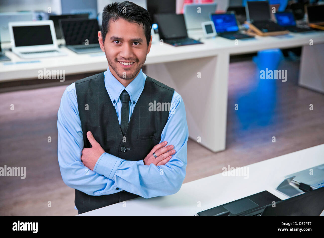 Salesman smiling in store Stock Photo - Alamy