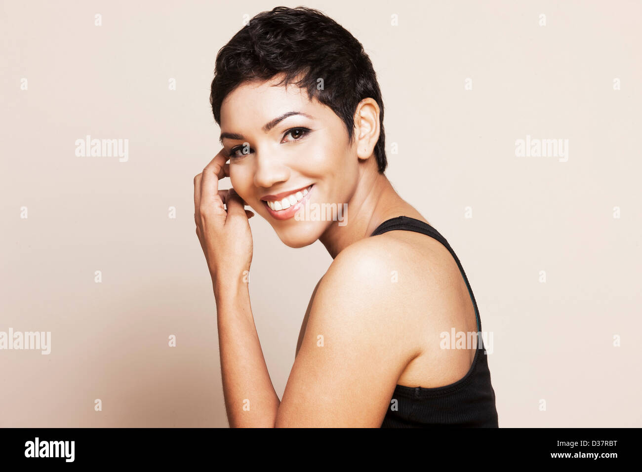 Smiling woman standing indoors Stock Photo - Alamy