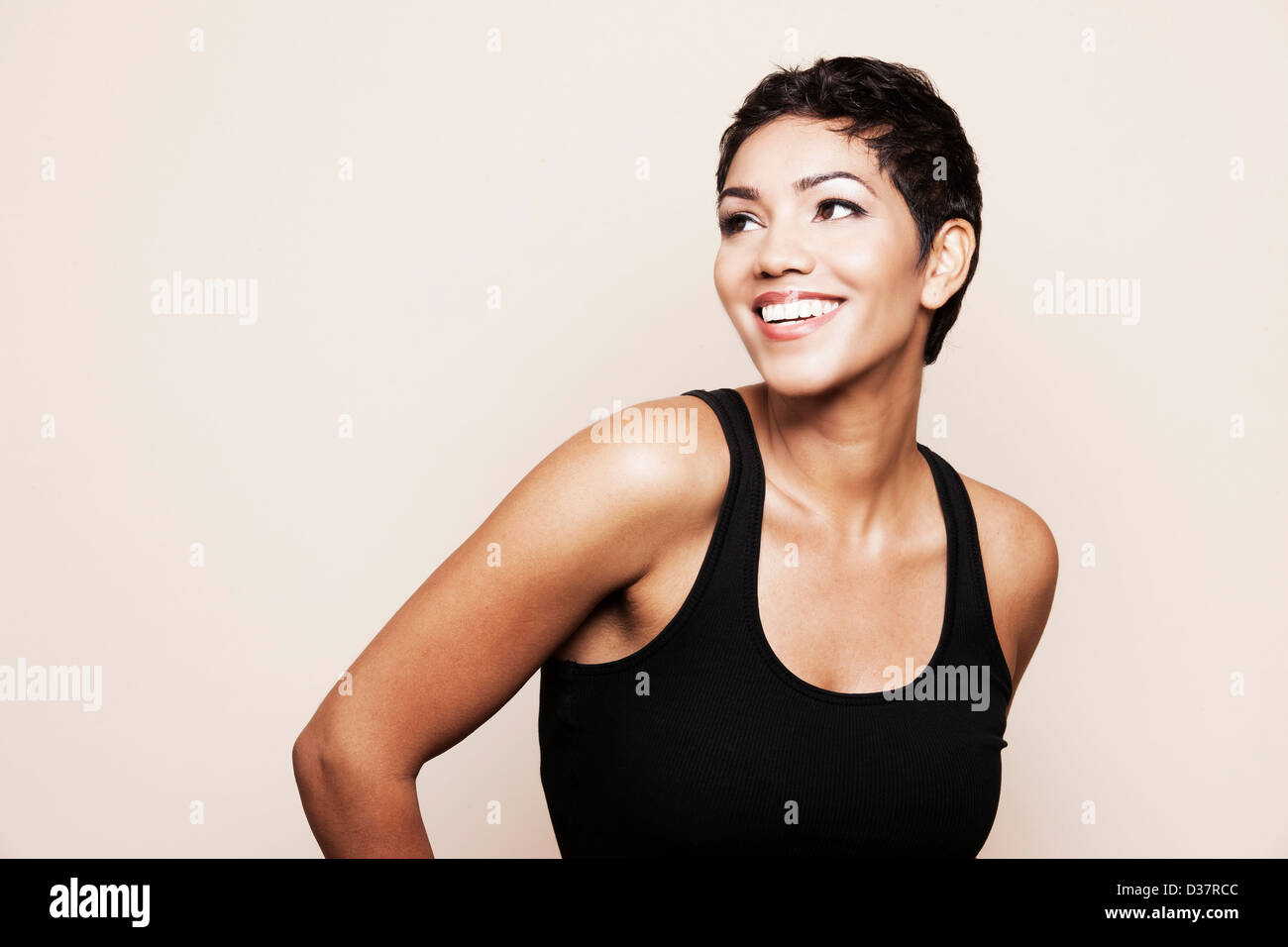 Smiling woman standing indoors Stock Photo - Alamy