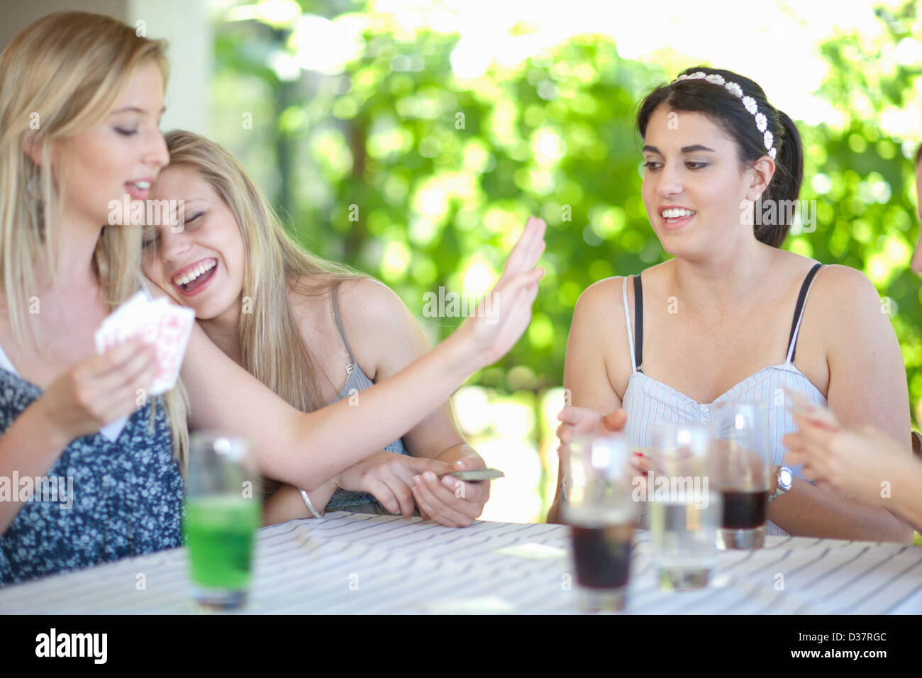 Women playing cards at table Stock Photo - Alamy