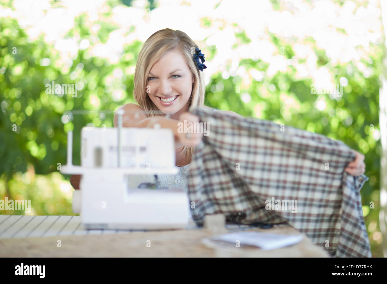 Woman working on sewing machine Stock Photo - Alamy
