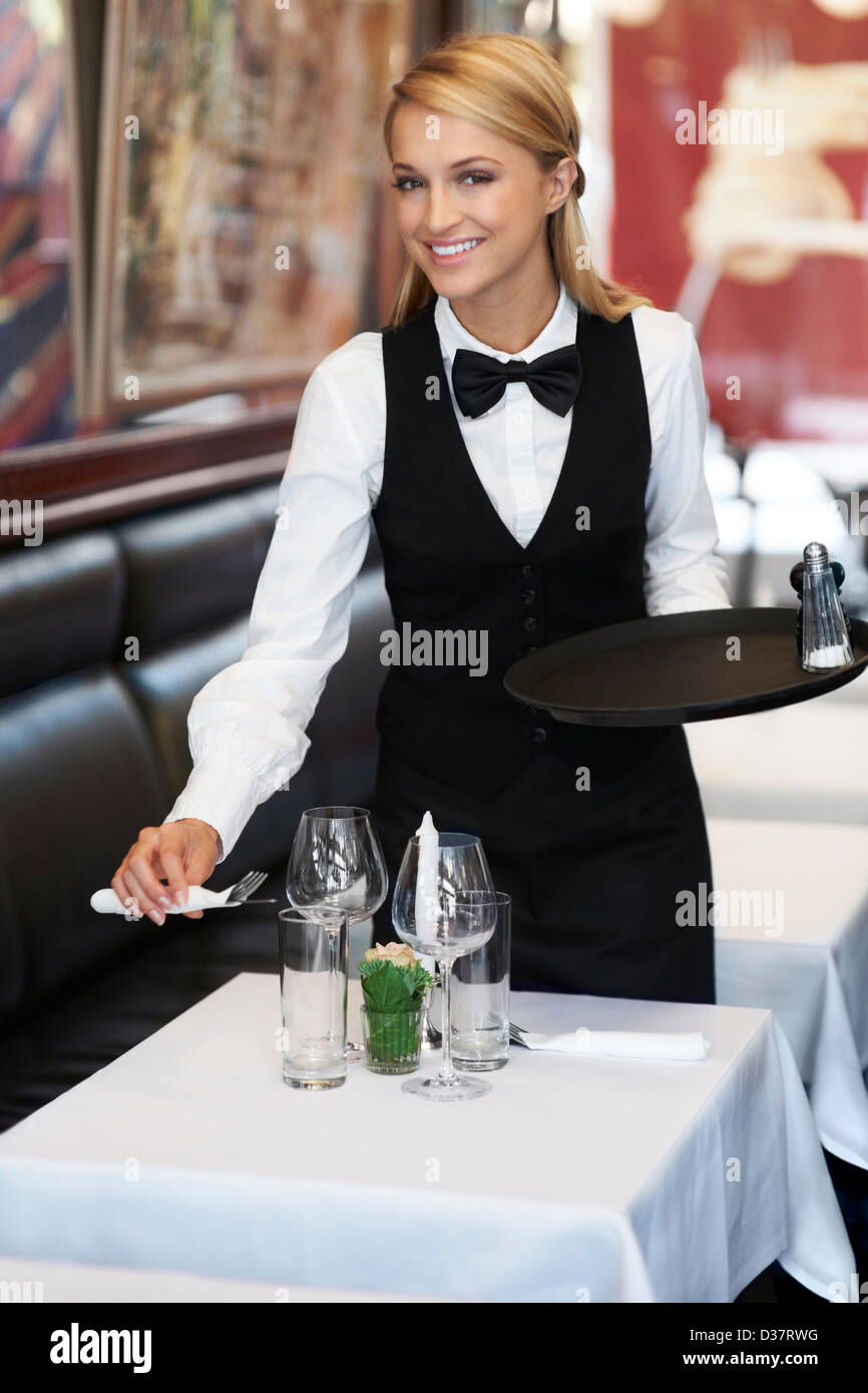 Denmark, Aarhus, Portrait of young waitress setting table Stock Photo ...
