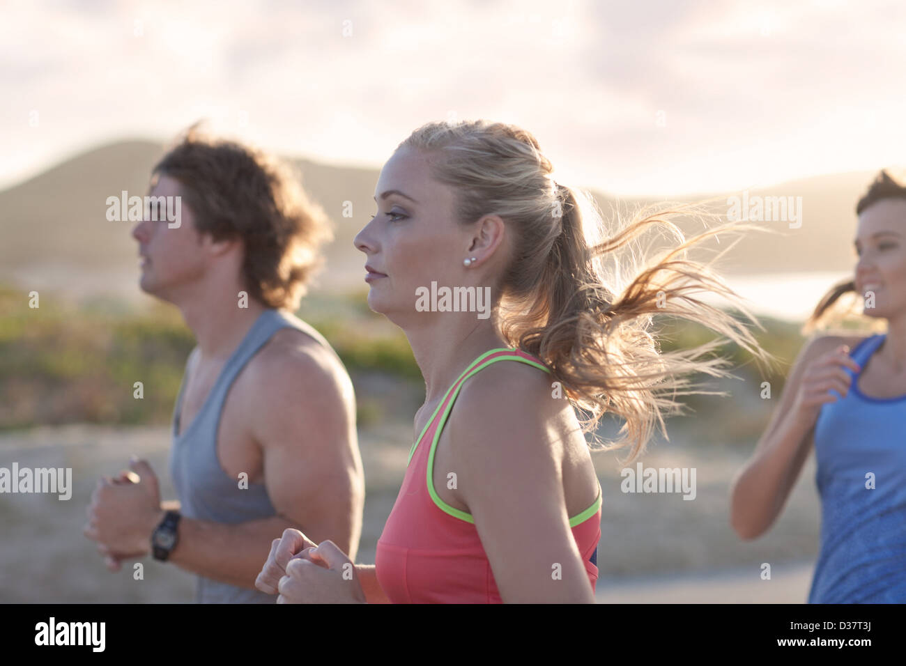 Friends running on beach Stock Photo - Alamy