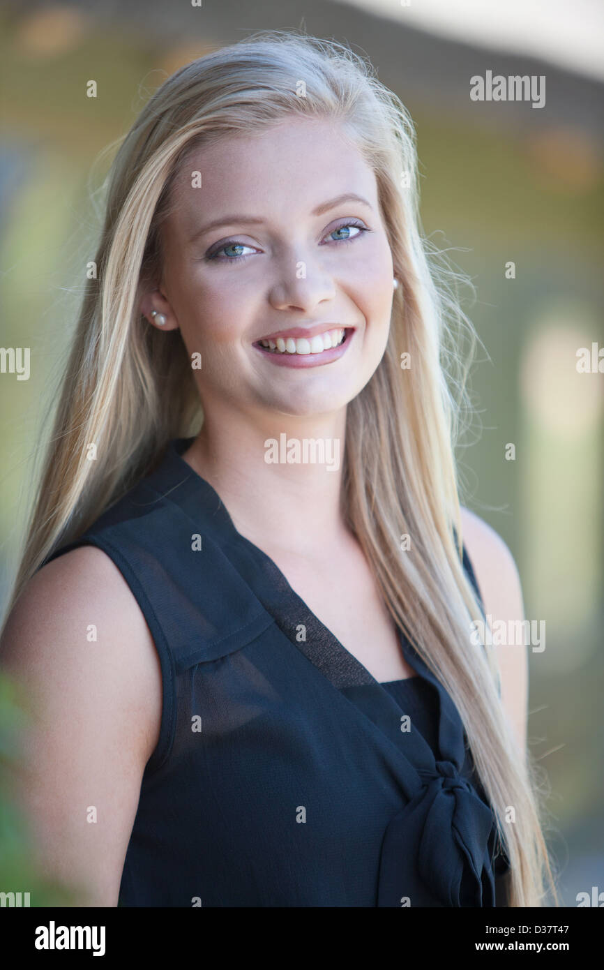 Smiling woman standing outdoors Stock Photo - Alamy