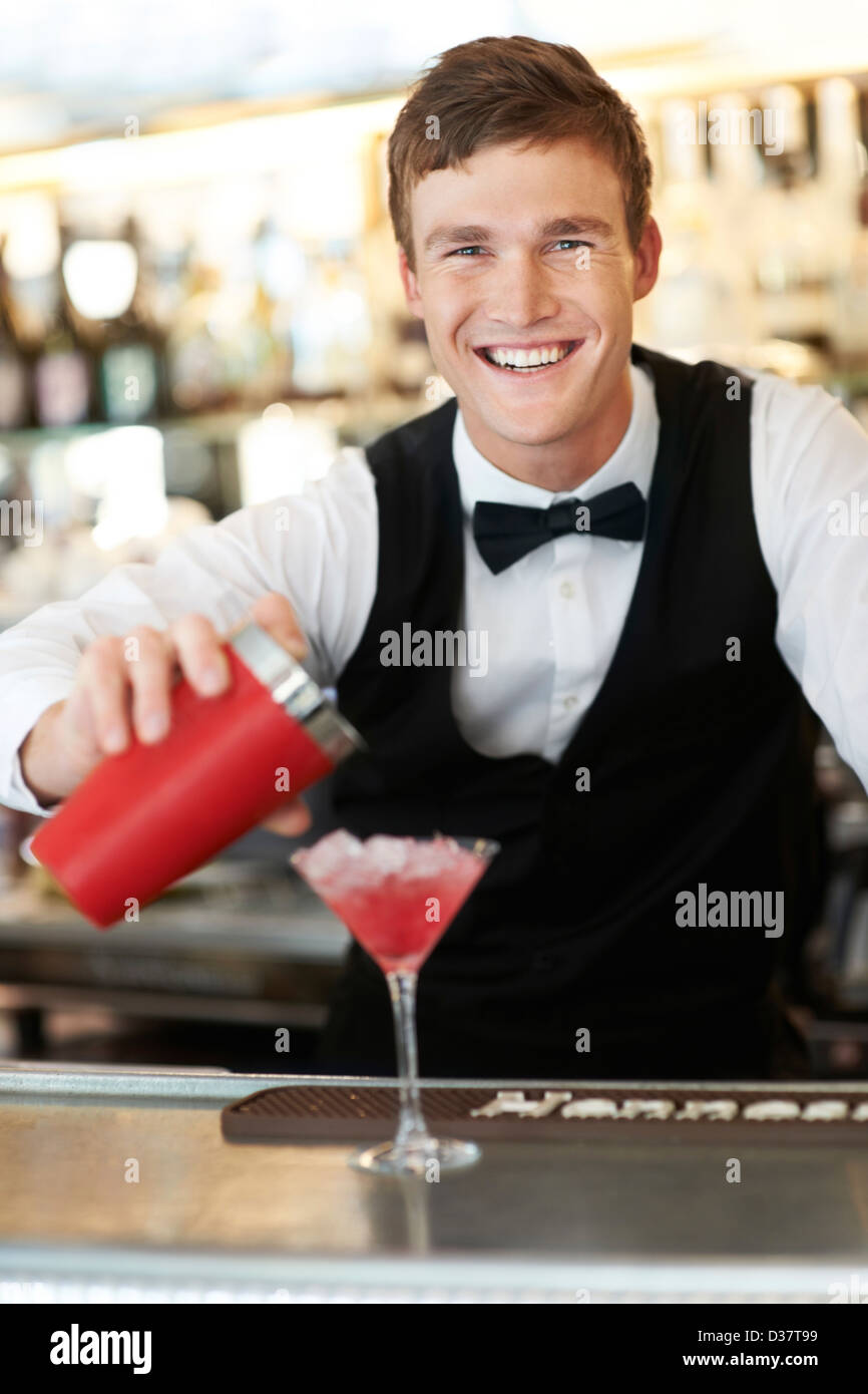 Denmark, Aarhus, Young bartender pouring cocktail Stock Photo - Alamy