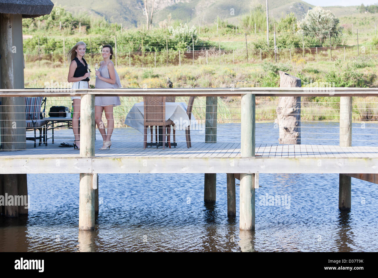 Women standing on wooden deck outdoors Stock Photo - Alamy