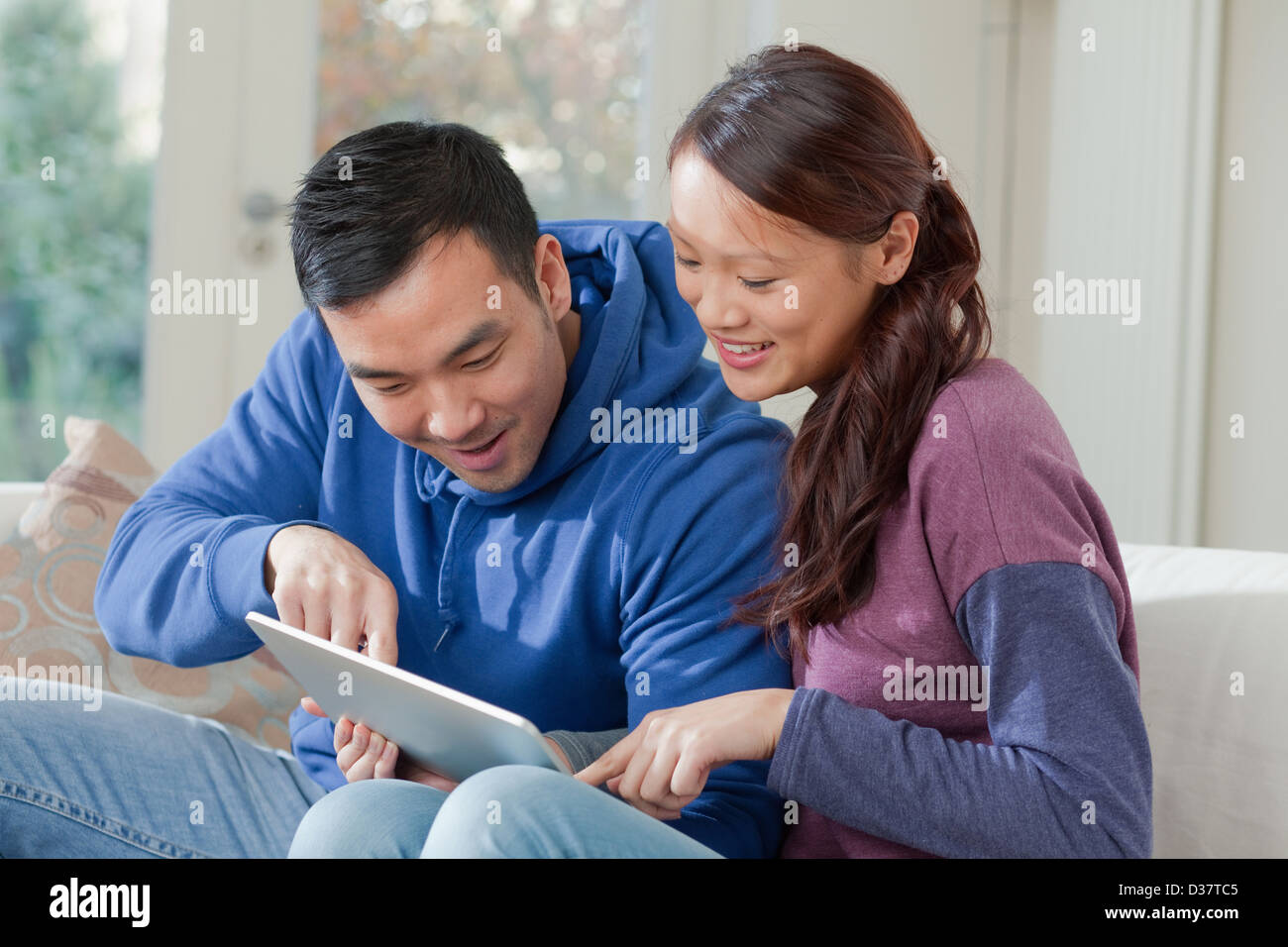 Couple using tablet computer together Stock Photo - Alamy