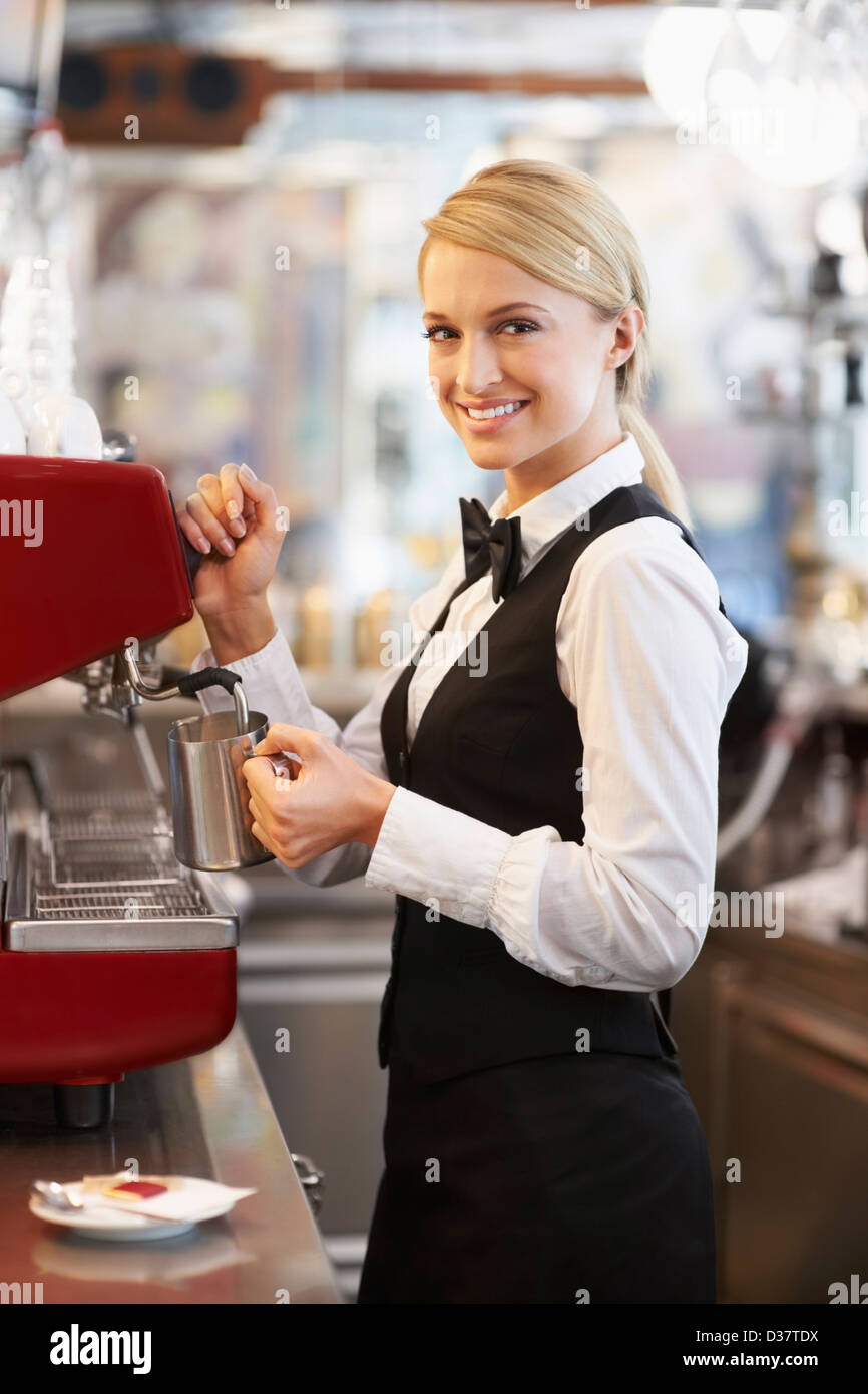 Denmark, Aarhus, Female barista steaming milk Stock Photo - Alamy