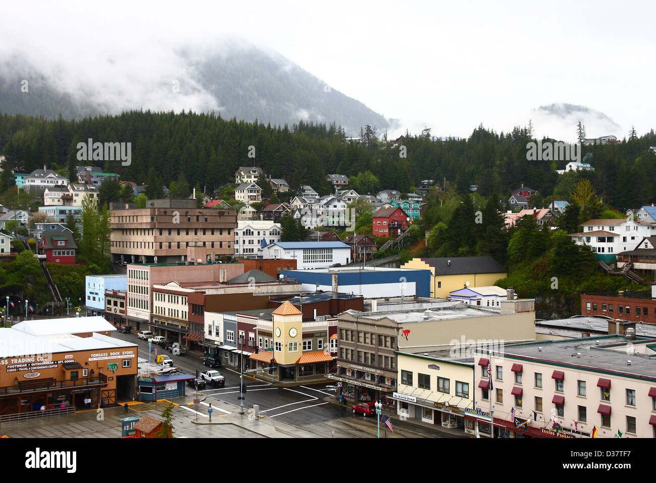 Colorful storefronts of Ketchikan Alaska with misty mounains in ...