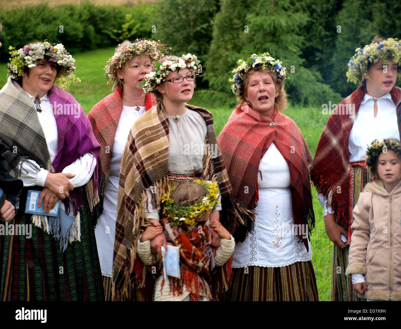 Latvians with summer wildflower wreath and National folklore costumes ...