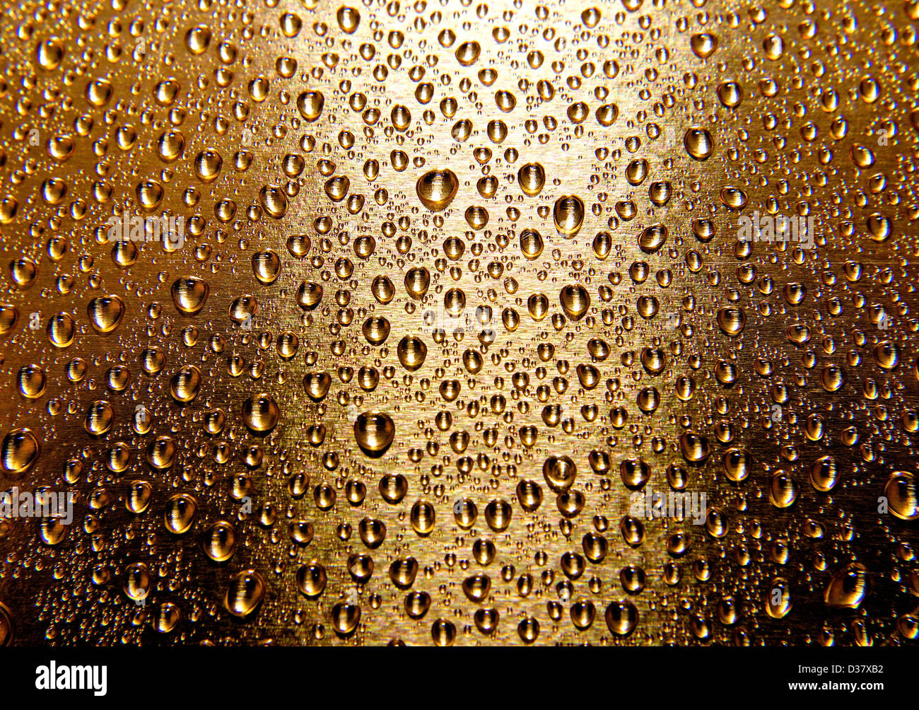 water droplets on a golden yellow surface Stock Photo - Alamy