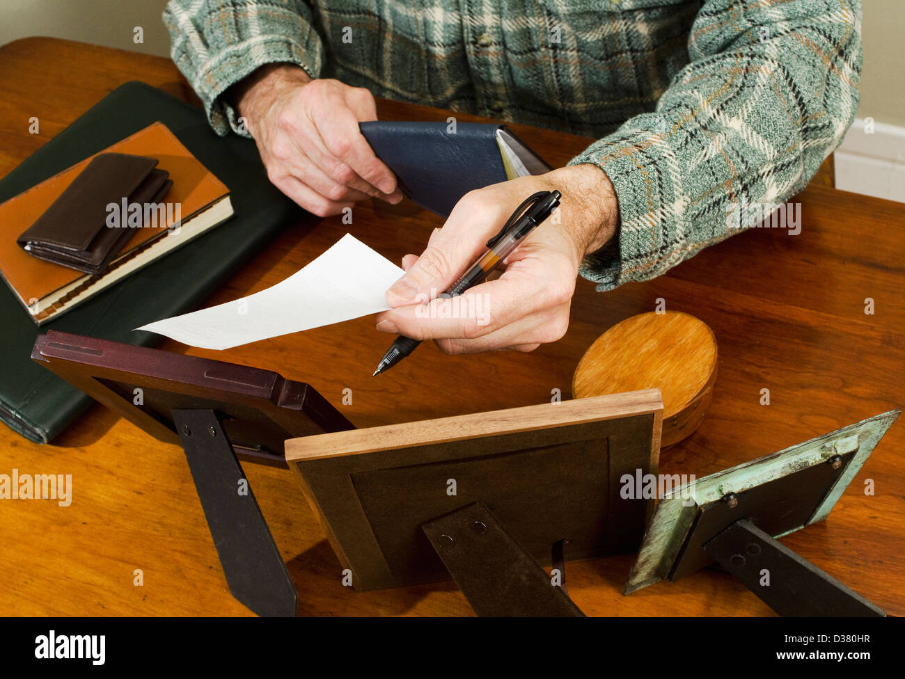 man handing personal check to unrecognizable person Stock Photo - Alamy