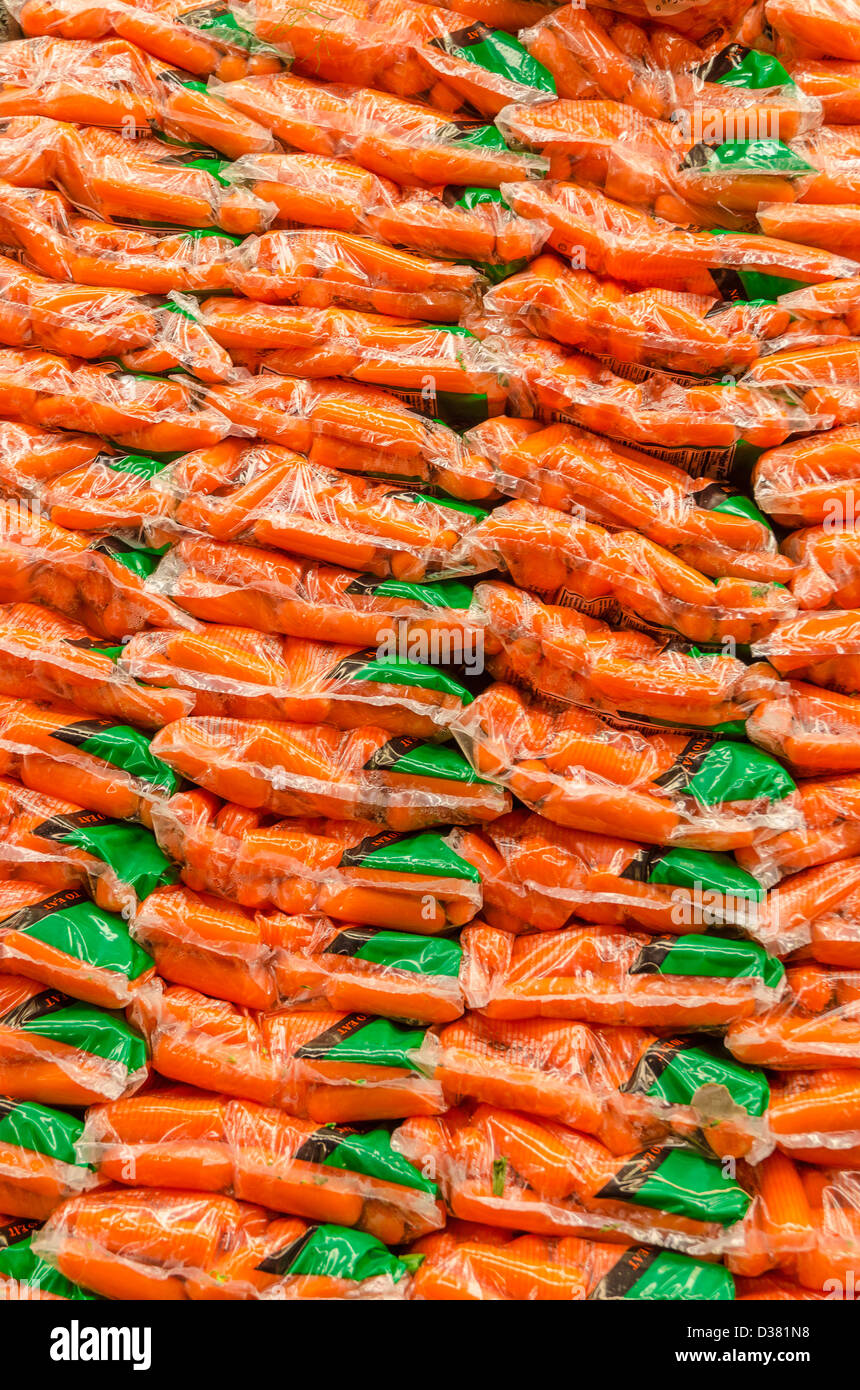 USA, New York, Brooklyn, Stack of plastic bags packed with carrots ...