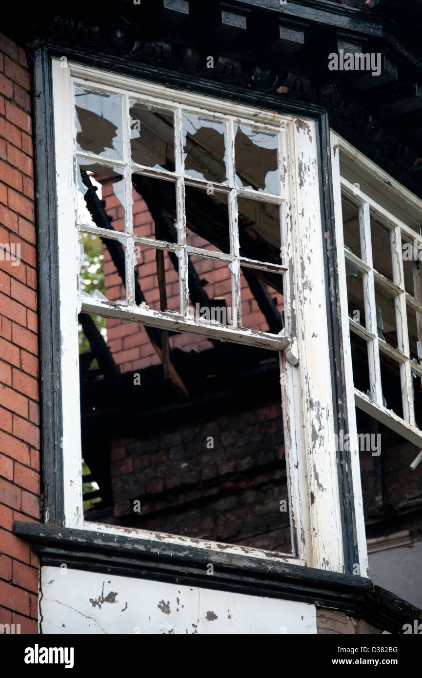Smashed derelict window of house after arson fire Stock Photo - Alamy