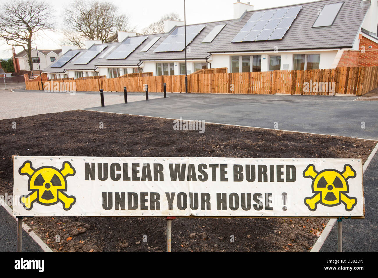 Montage of eco houses and nuclear dump poster Stock Photo - Alamy
