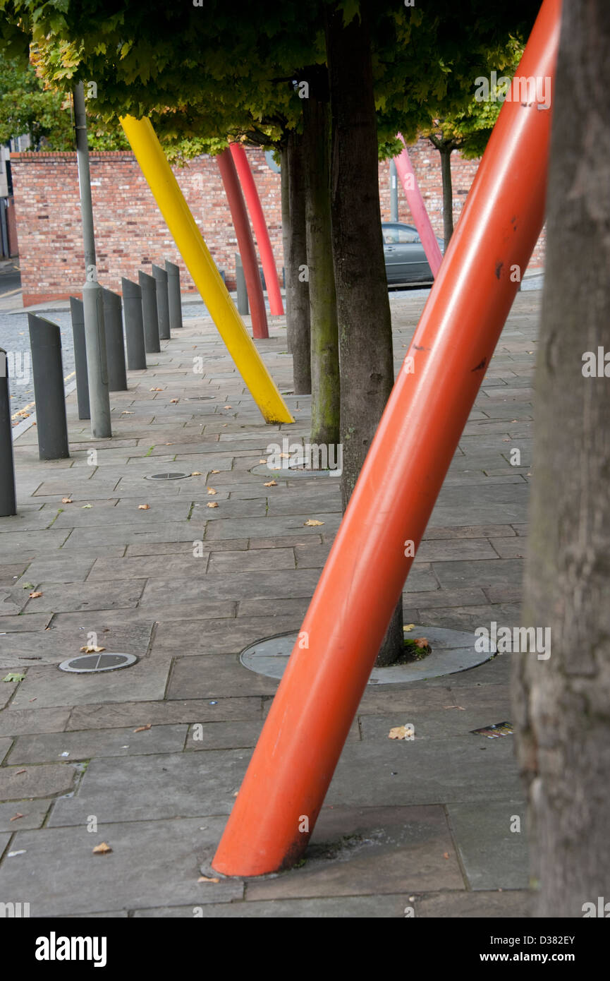 Brightly coloured modern art tree trunks steel Stock Photo - Alamy