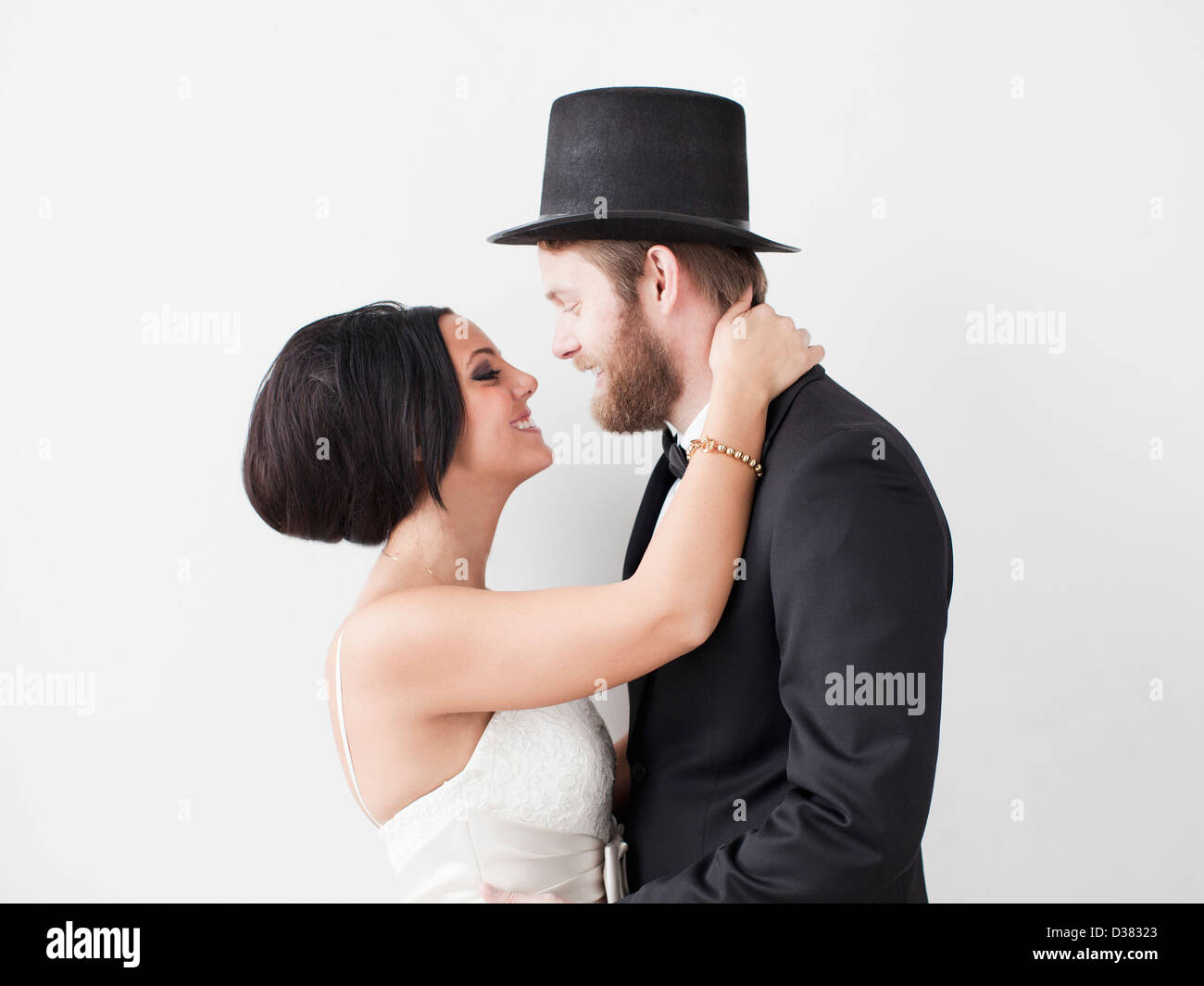 Studio Shot portrait of bride and groom smiling face to face Stock ...