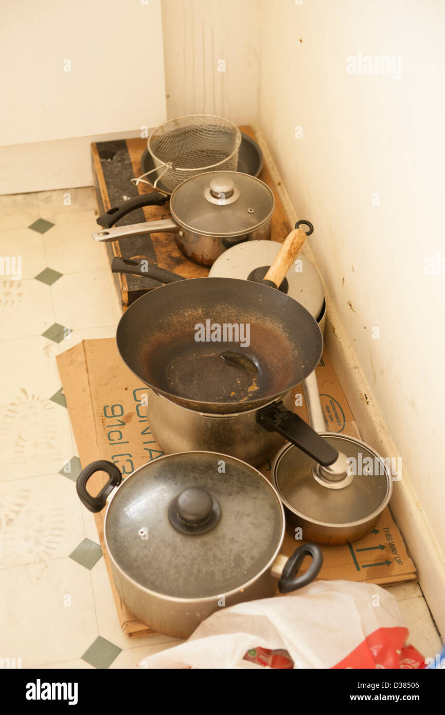 Dirty Chinese food pans on floor of dirty kitchen Stock Photo - Alamy