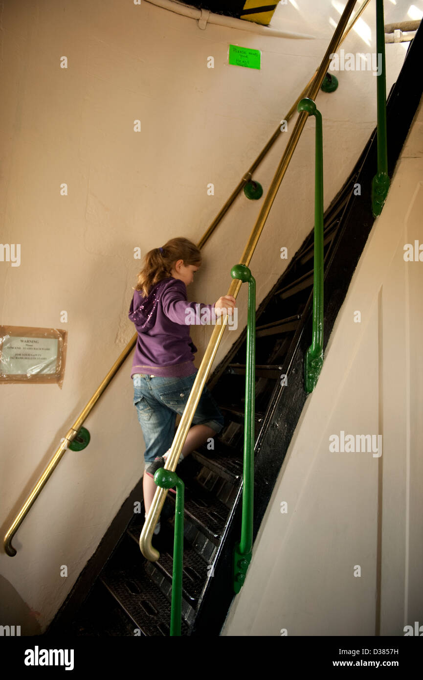 Young girl climbing spiral staircase in lighthouse FULLY MODEL RELEASED ...