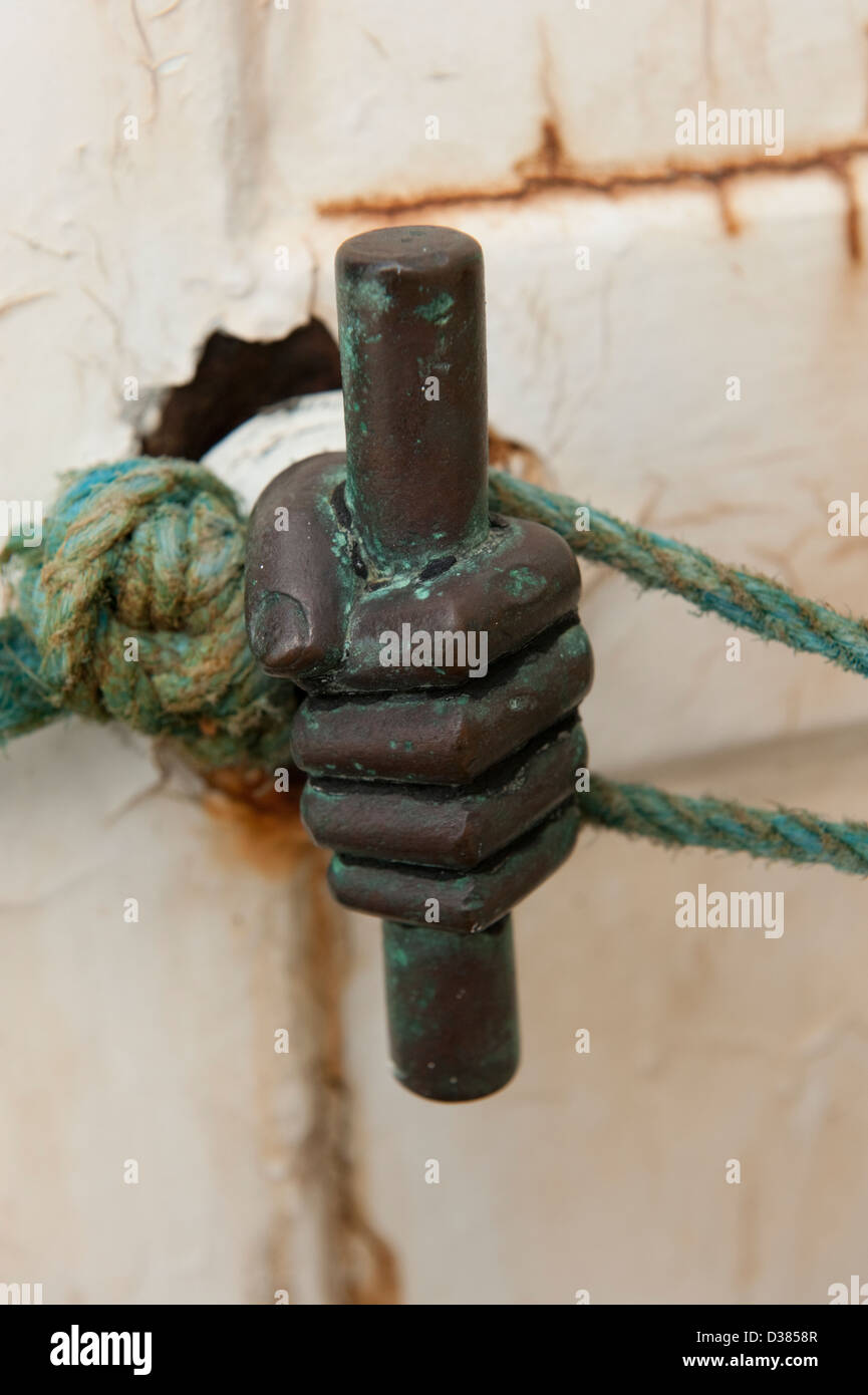 Cast Bronze clenched fist hand rope art deco Stock Photo - Alamy