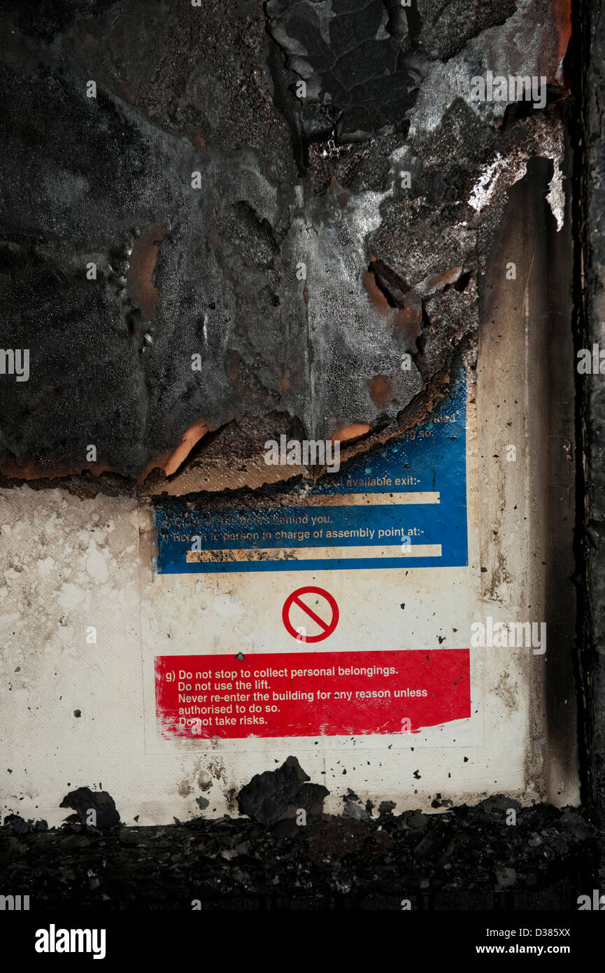 Fire Action Safety Sign Partly burnt in factory fire Stock Photo - Alamy