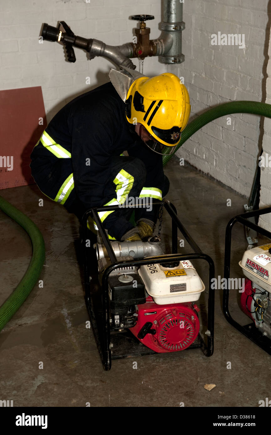 Fireman using LPP Light Portable Pump Flooding Stock Photo - Alamy