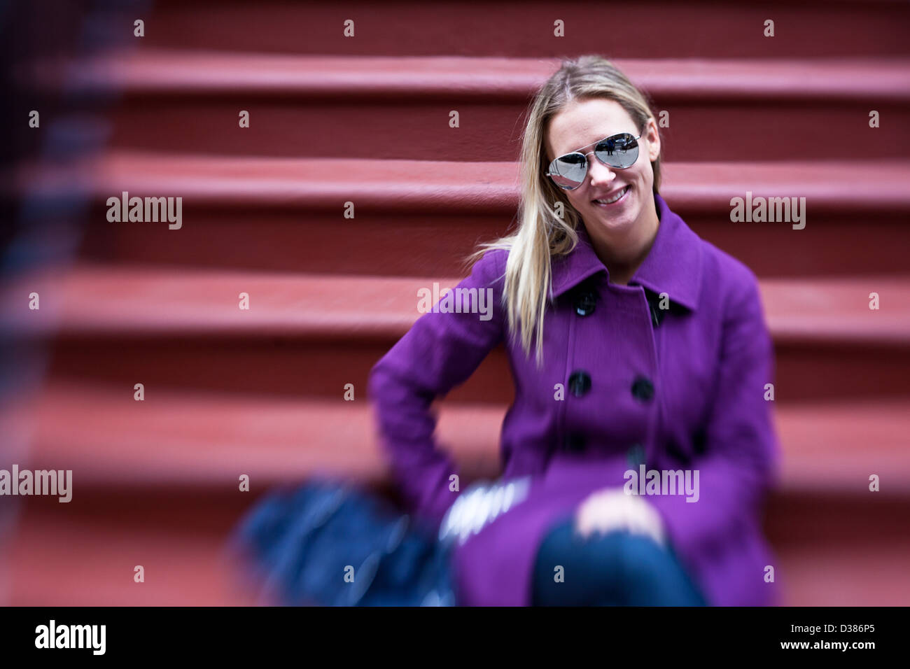 Young woman sitting on stoop hi-res stock photography and images - Alamy