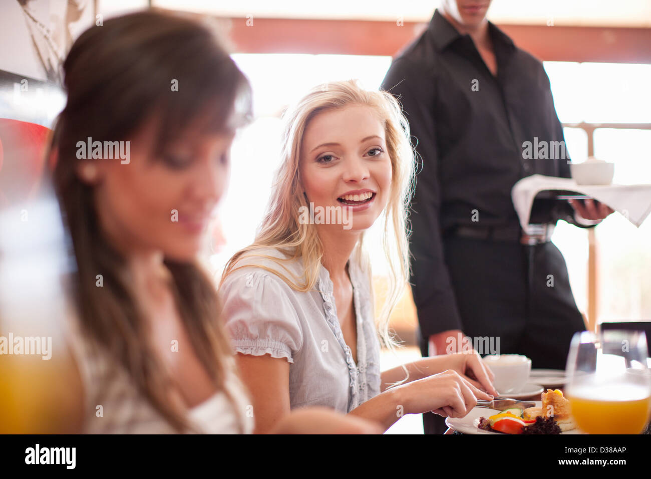 Women having breakfast together in cafe Stock Photo - Alamy