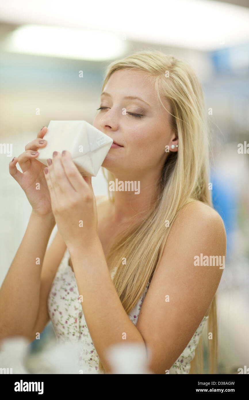 Woman smelling candle in store Stock Photo - Alamy