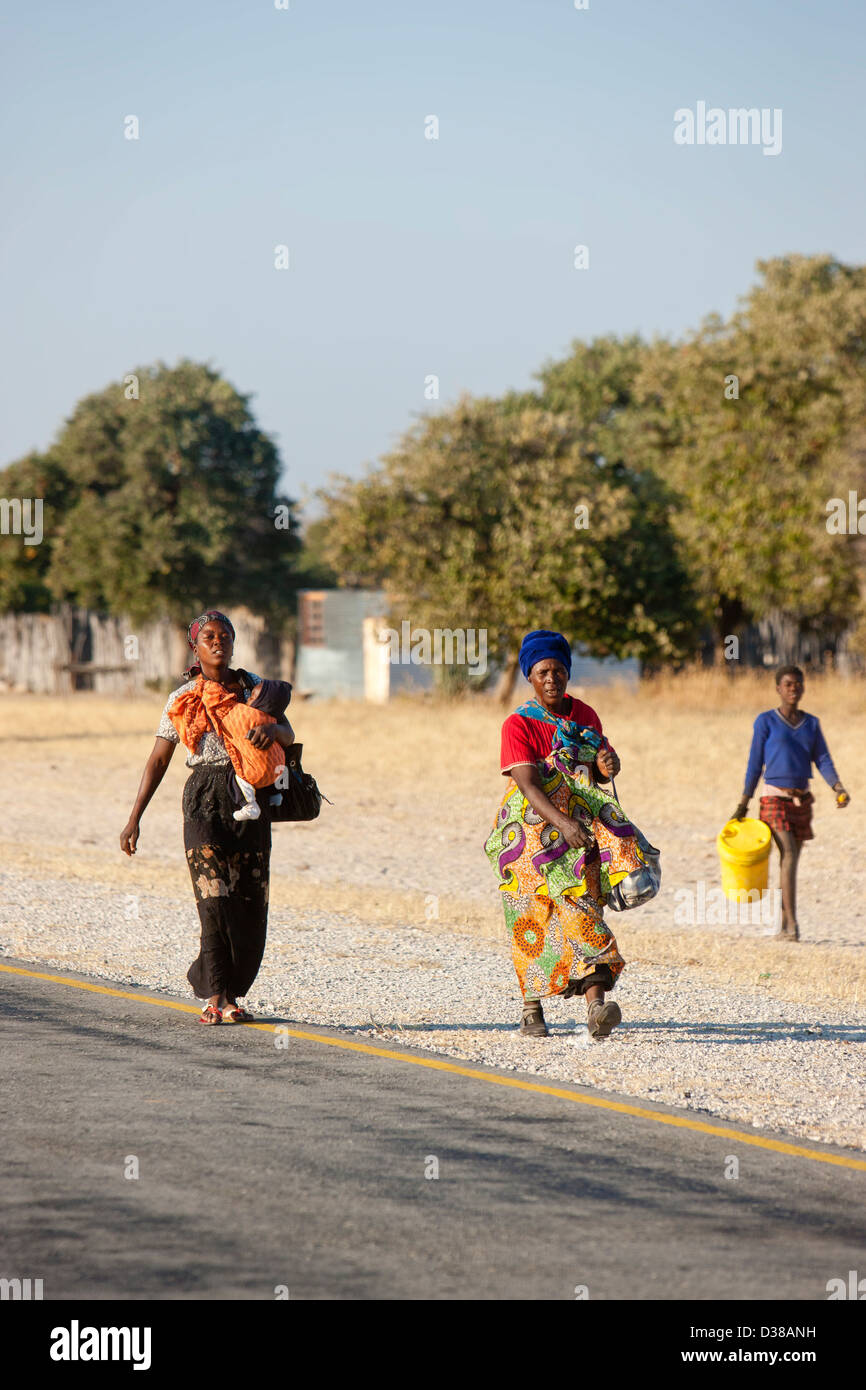 Traditional woman walking on road near Rundu Village in Namibia Stock ...