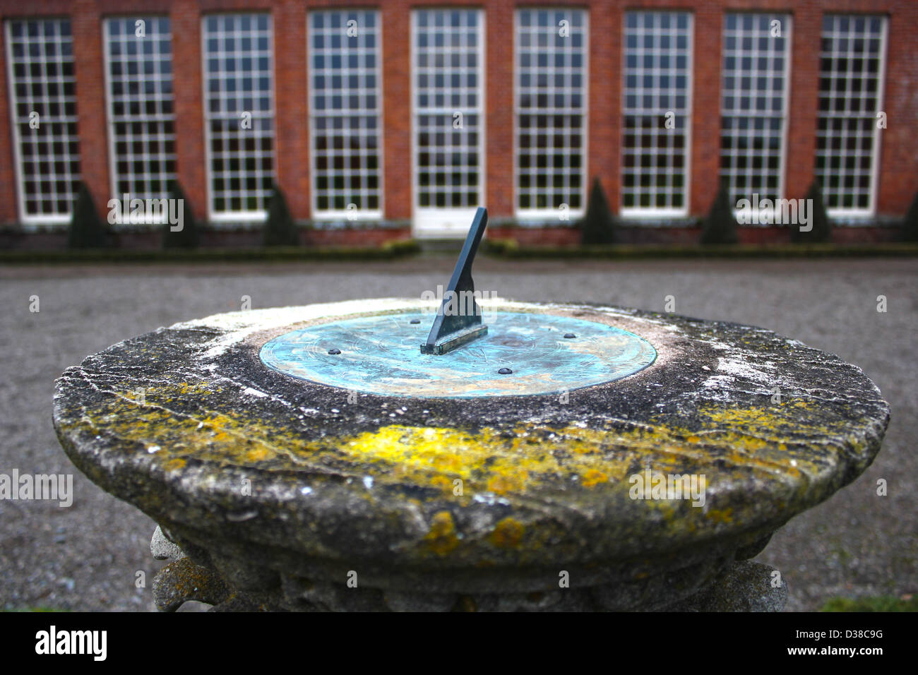 A closeup of sun dial with blurred background of windows Stock Photo ...