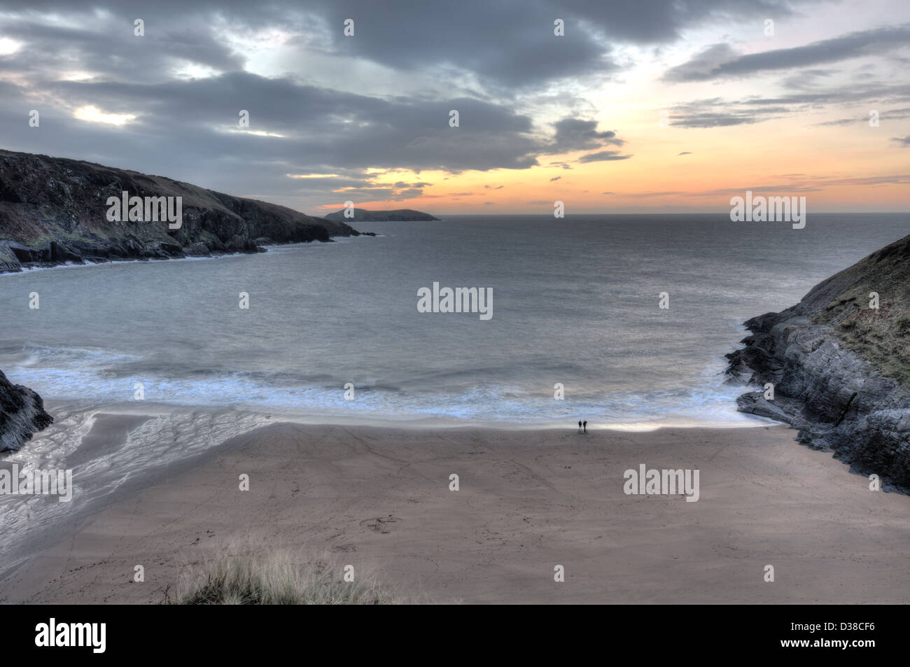 Couple at sunset on Mwnt beach with Cardigan Island and Bay in ...