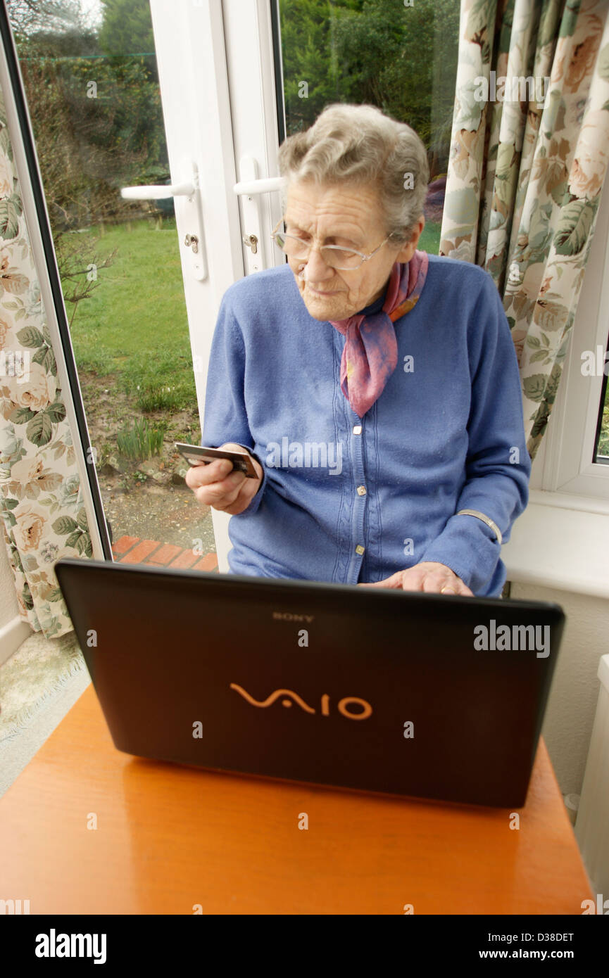 Elderly woman using a laptop computer (many seniors are now computer ...