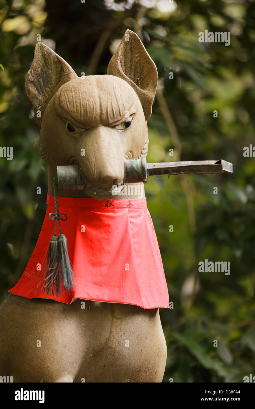 Kitsune, the god rice fox messenger statue in fushimi inari shrine near ...