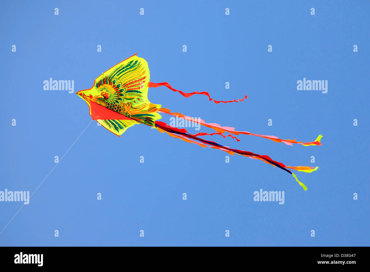 Beautiful bright kite in the blue sky Stock Photo - Alamy