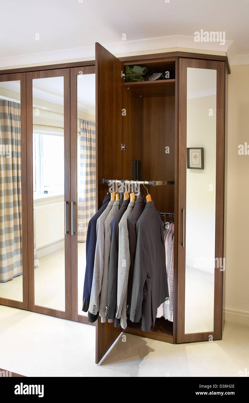 A mirrored wardrobe in a bedroom in a home in the UK Stock Photo - Alamy