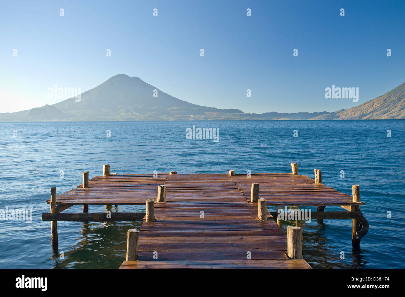 Wooden pier in still lake Stock Photo - Alamy