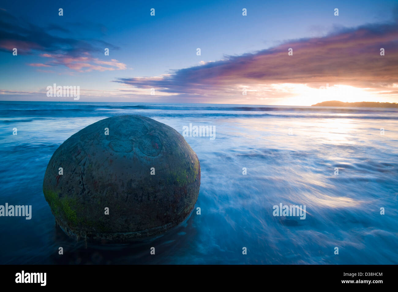 Waves washing over rock on beach Stock Photo - Alamy