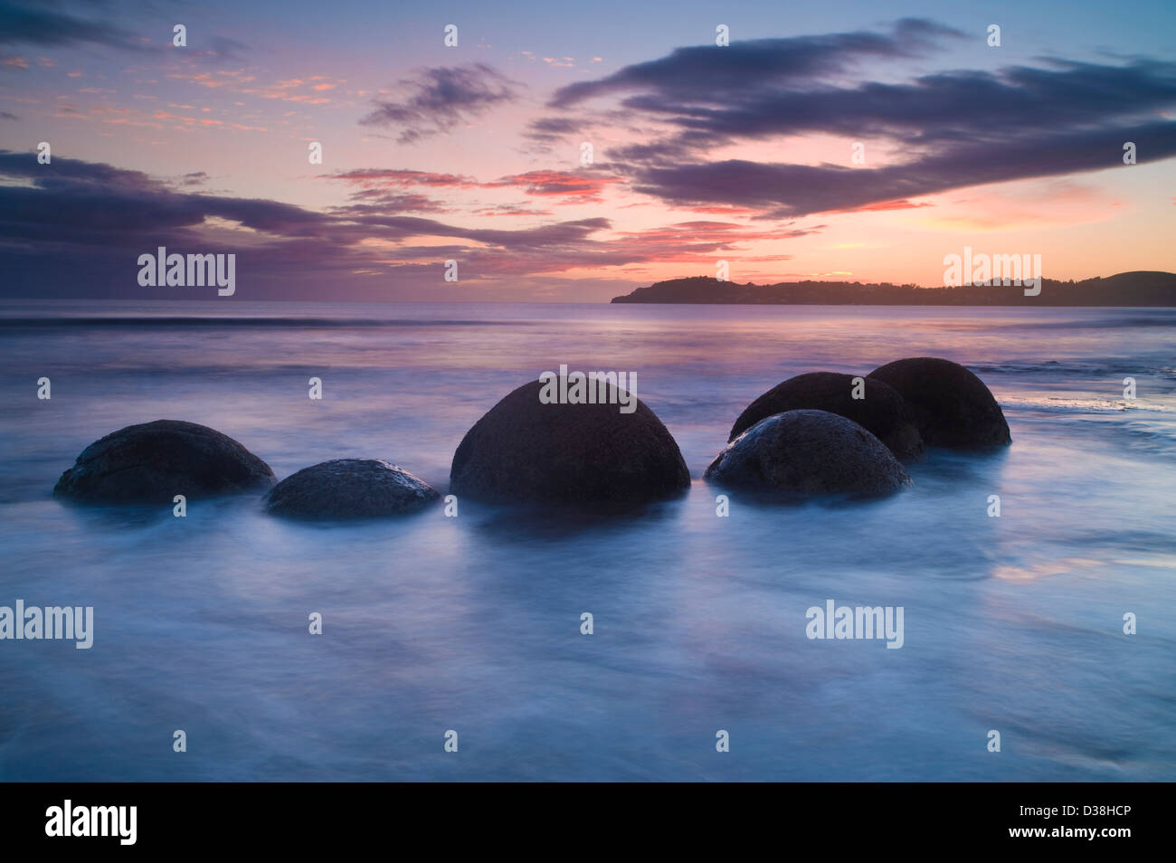 Waves washing over rocks on beach Stock Photo - Alamy
