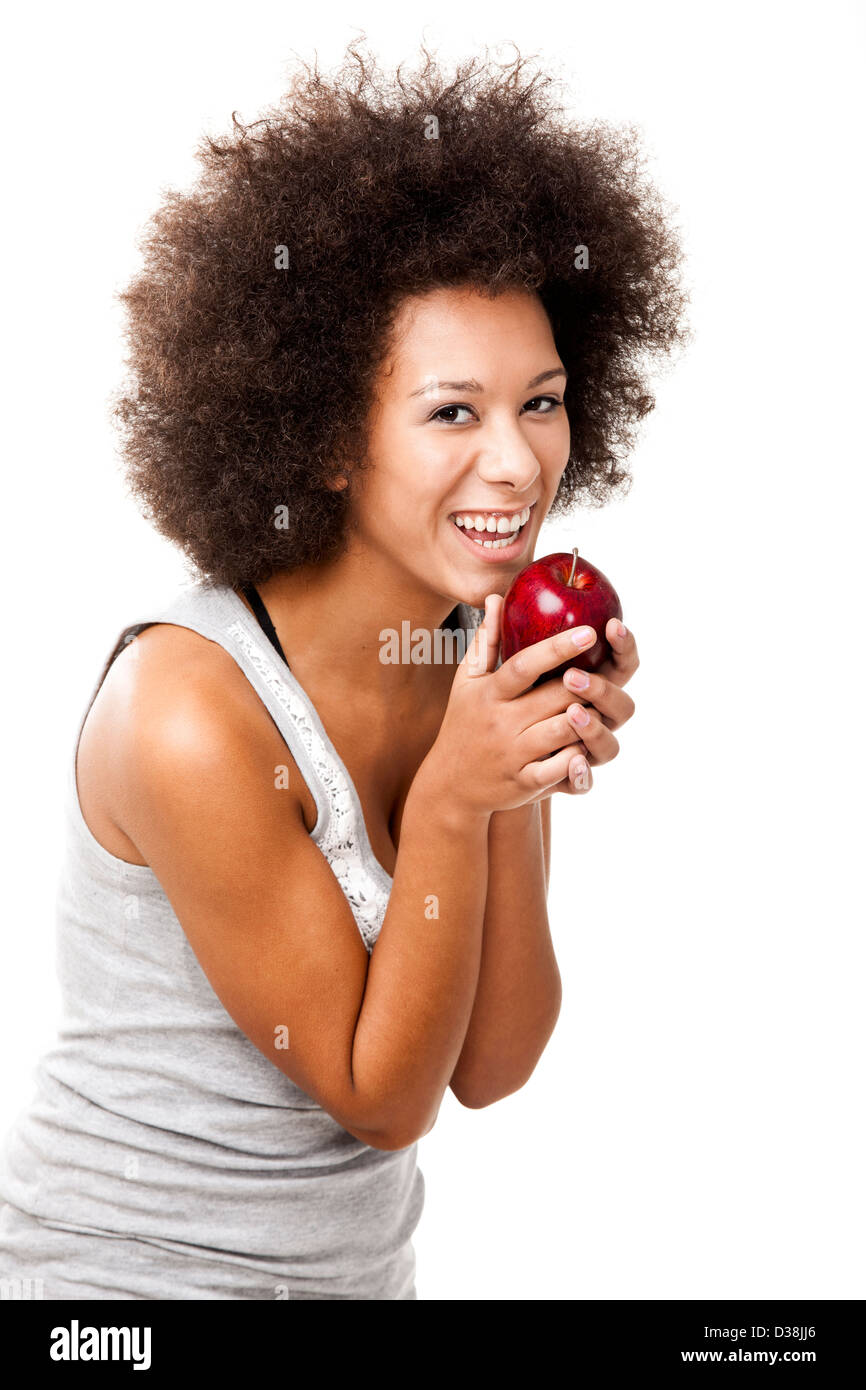 African American young woman holding and eating an apple Stock Photo ...