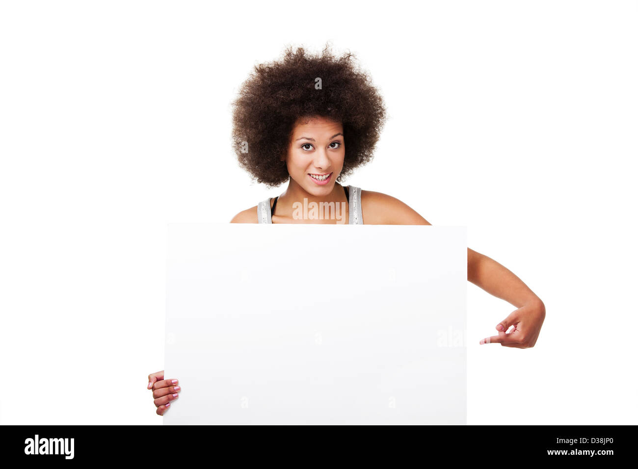 Beautiful young woman holding and pointing to a white billboard with ...
