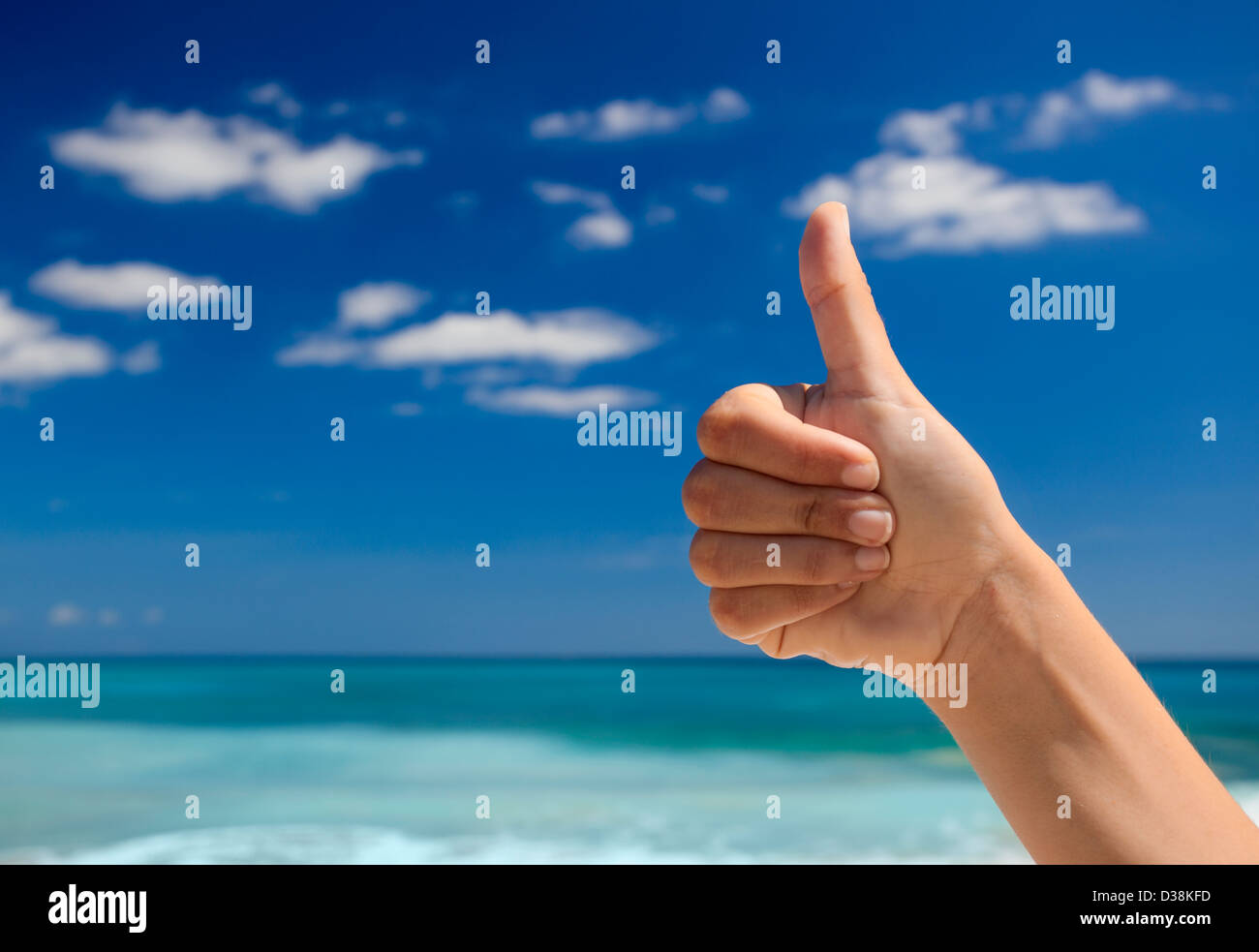 Female hand doing thumbs up against a beautiful blue sky Stock Photo ...