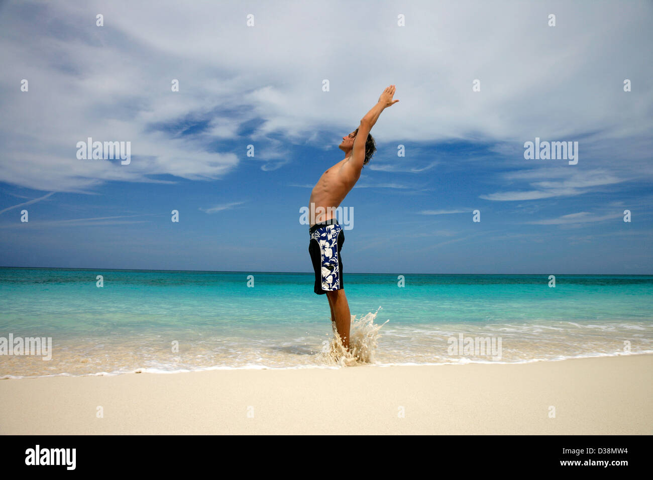Man practicing yoga on tropical beach Stock Photo - Alamy