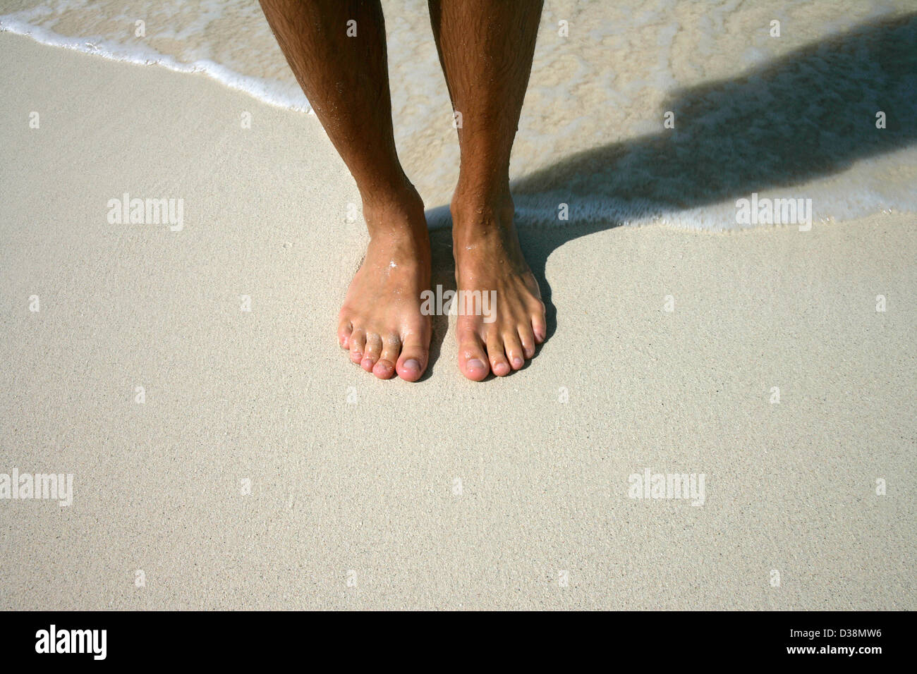 Close up of mans feet on beach Stock Photo - Alamy