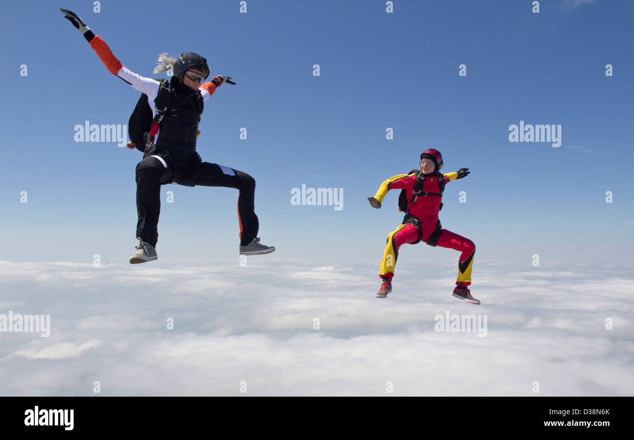 Women skydiving over clouds Stock Photo - Alamy