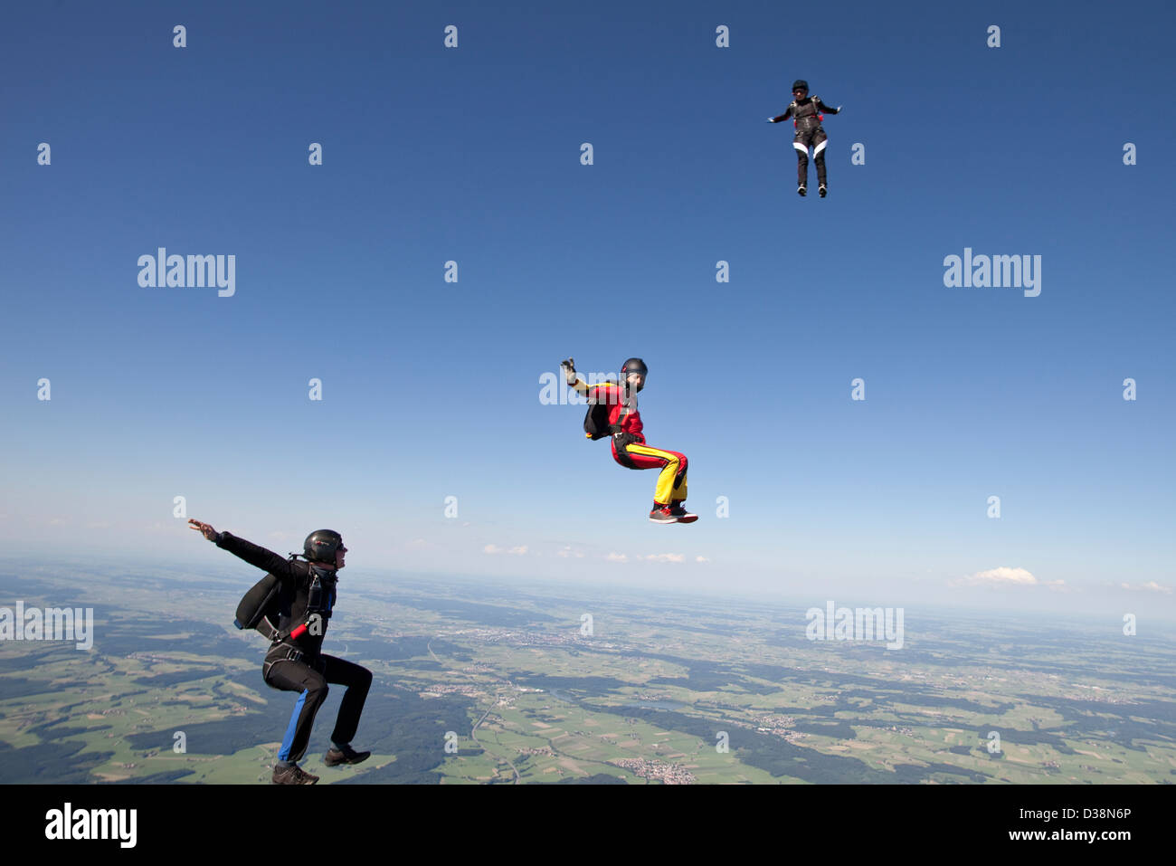 People skydiving over rural landscape Stock Photo - Alamy