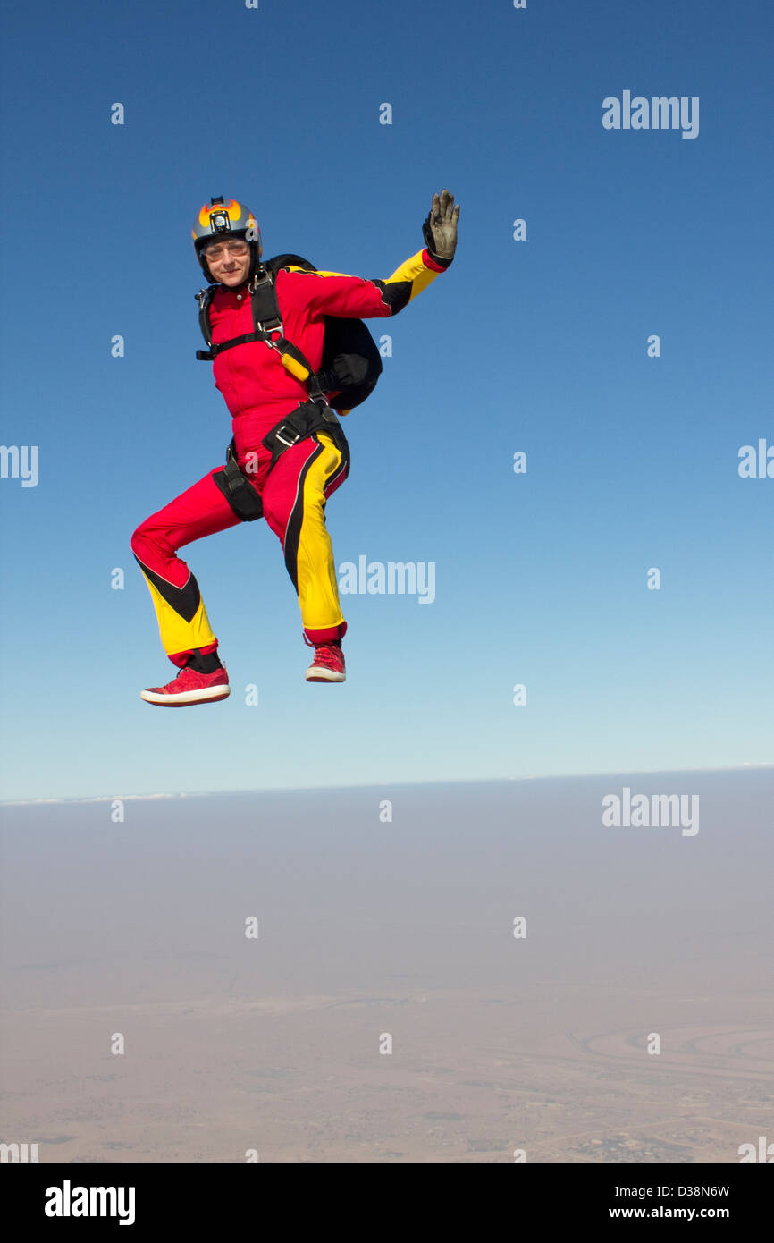 Woman skydiving over clouds Stock Photo - Alamy