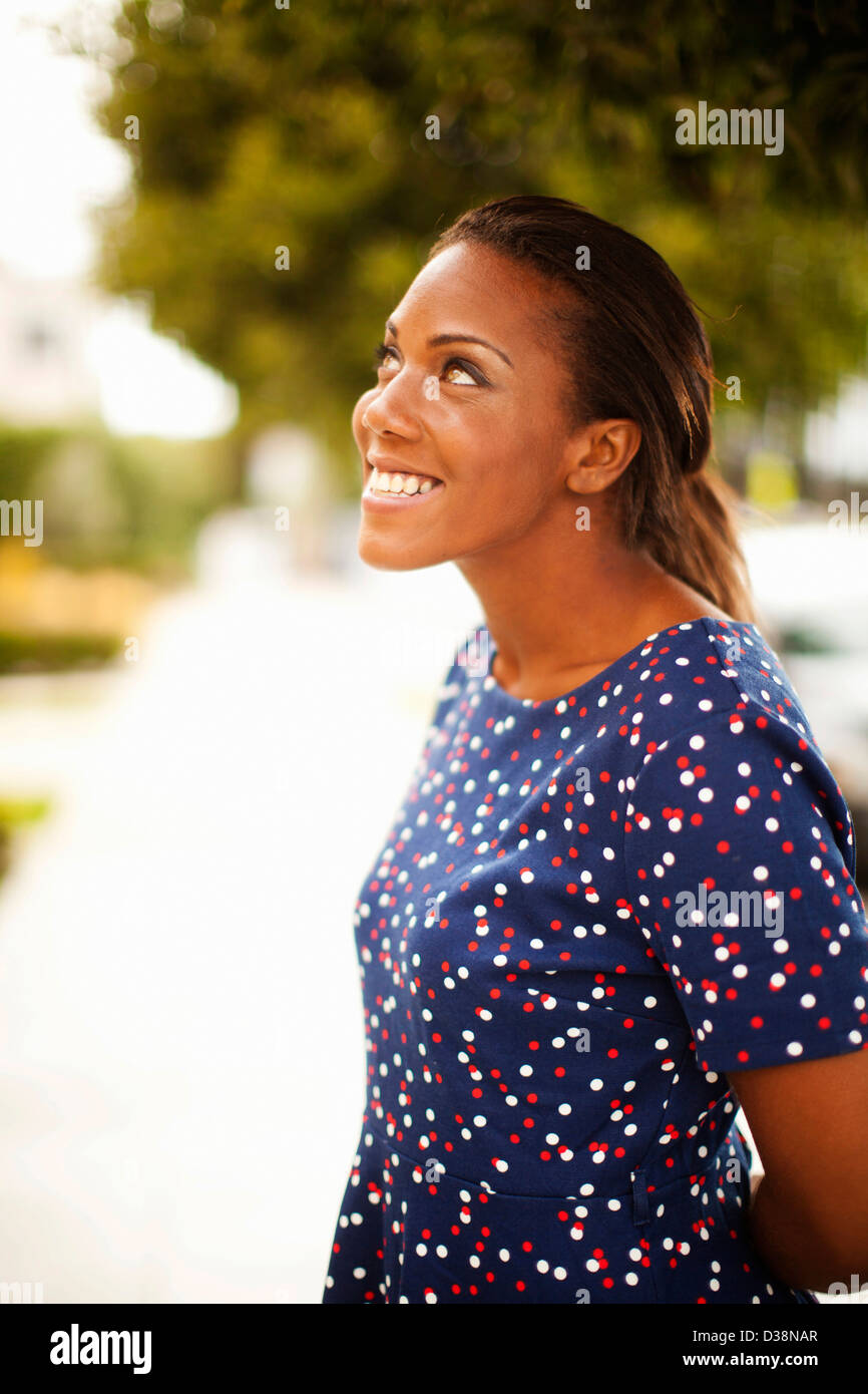 Smiling woman walking outdoors Stock Photo - Alamy