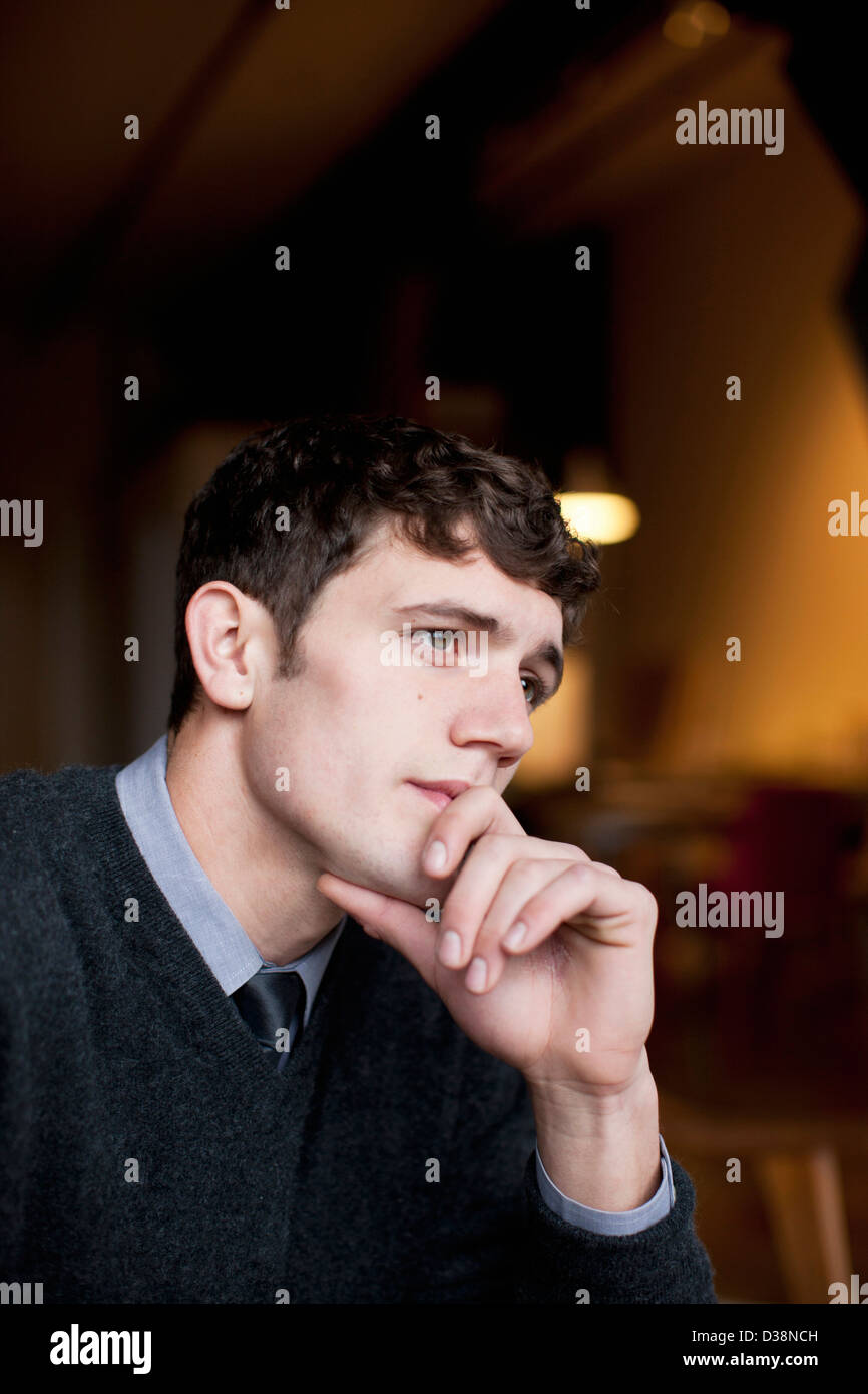 Businessman thinking with chin in hand Stock Photo - Alamy