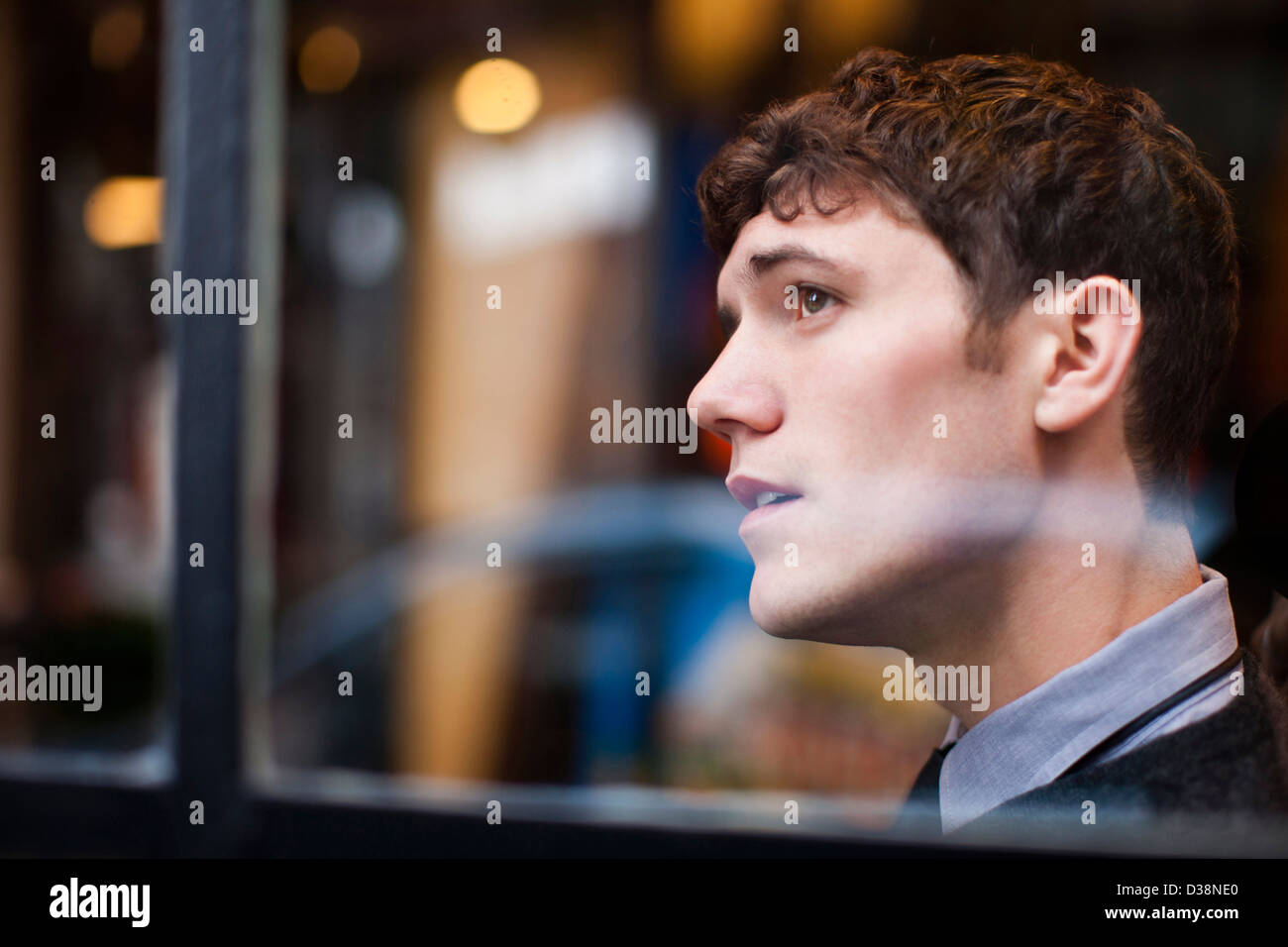 Businessman looking out window Stock Photo - Alamy